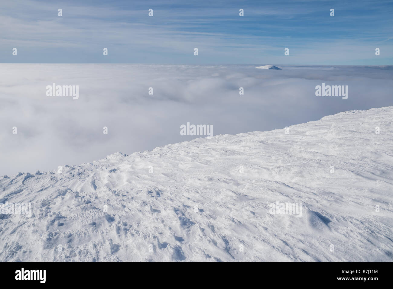 Mountain tops covered with snow above the white heavy clouds Stock ...