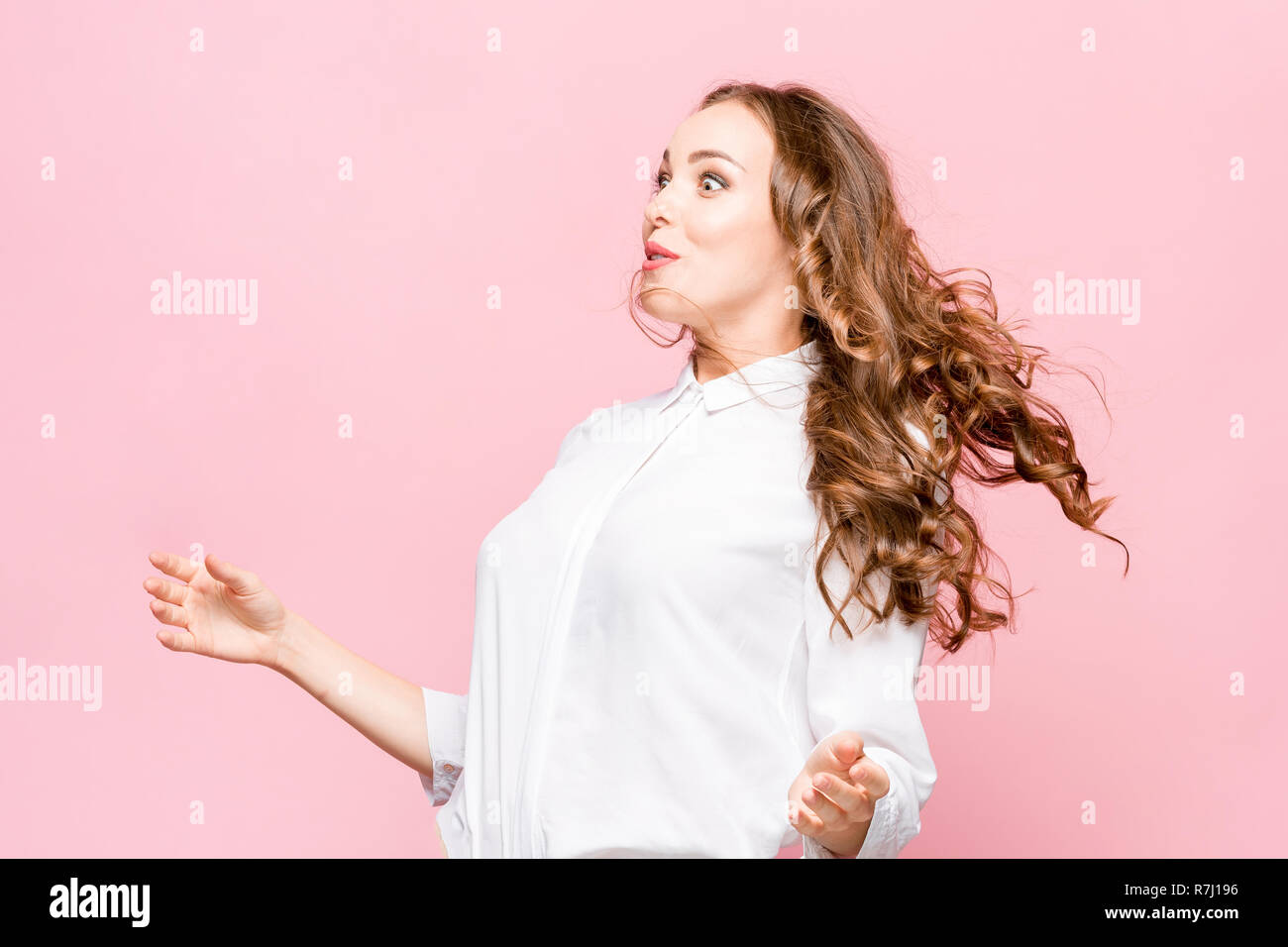 The young woman's portrait with happy emotions on pink background Stock ...