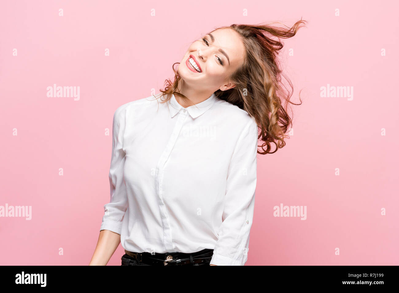 The young woman's portrait with happy emotions on pink background Stock ...