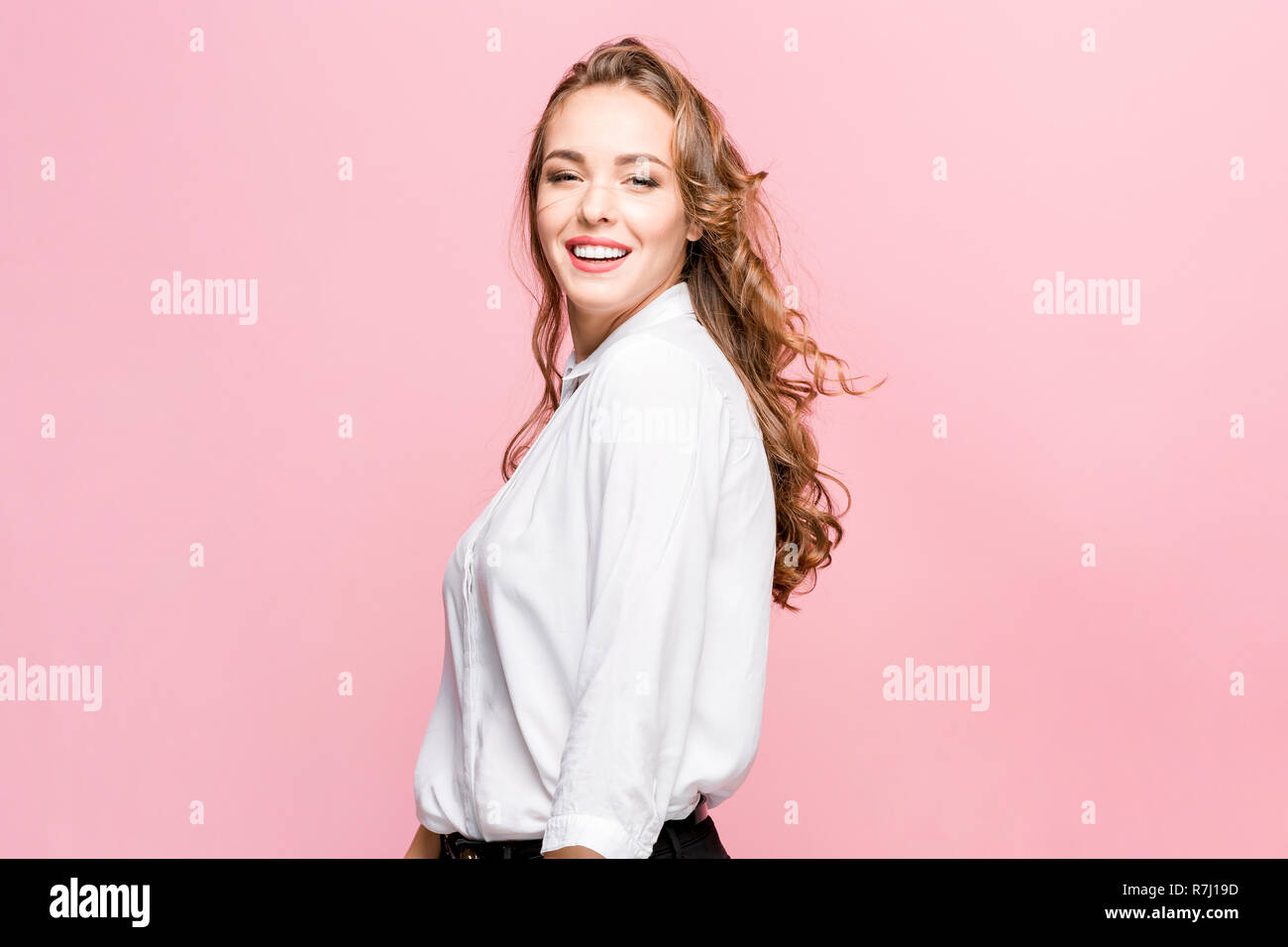 The young woman's portrait with happy emotions on pink background Stock ...