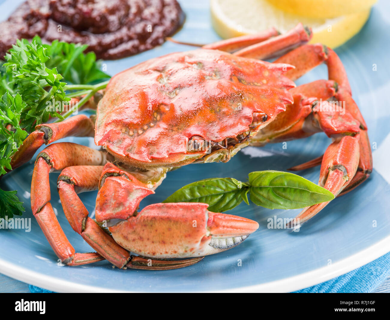 Seafood dish - cooked crab with lemon and herbs Stock Photo - Alamy