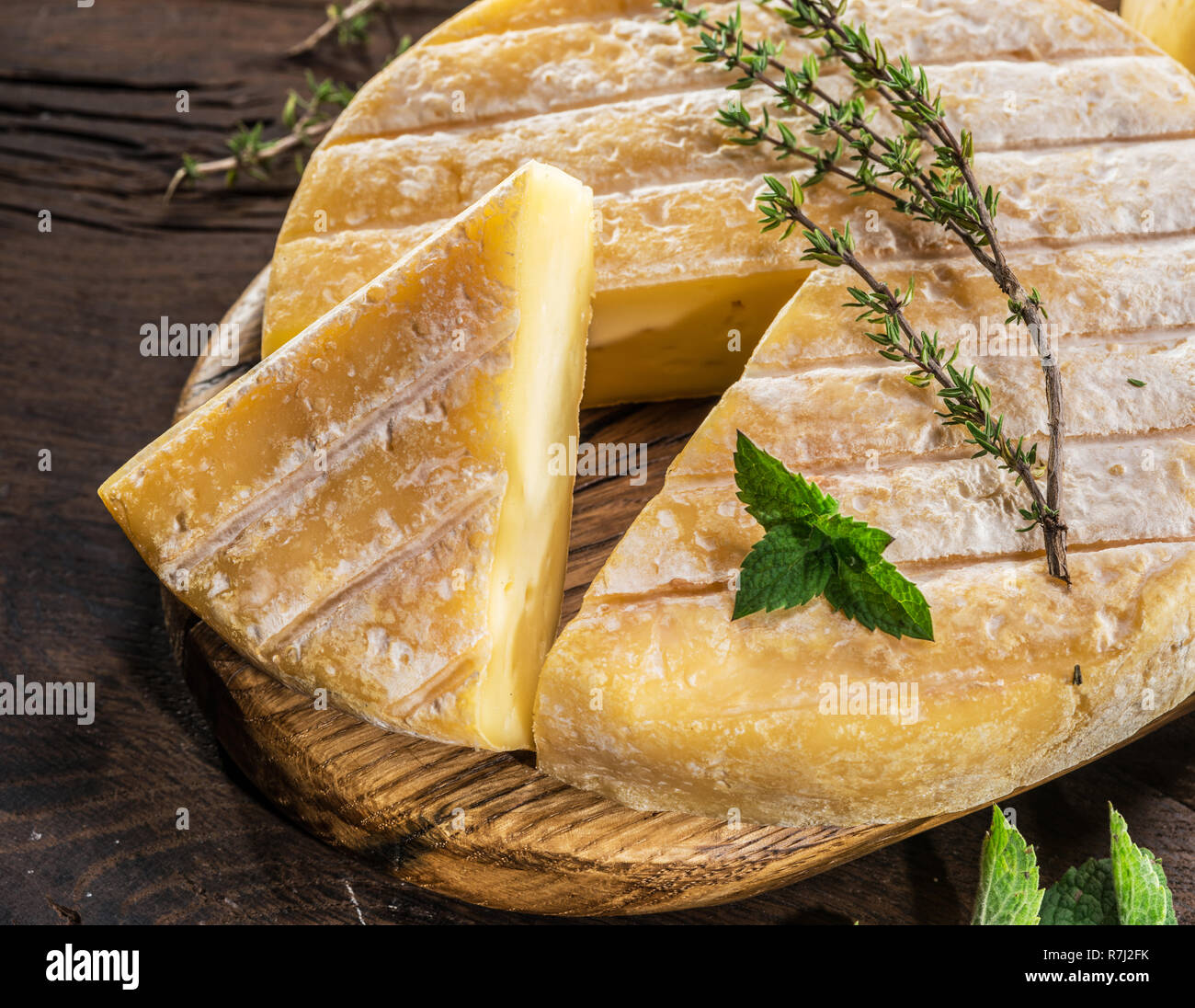 Homemade cheese wheel on the dark wooden background. Top view Stock ...