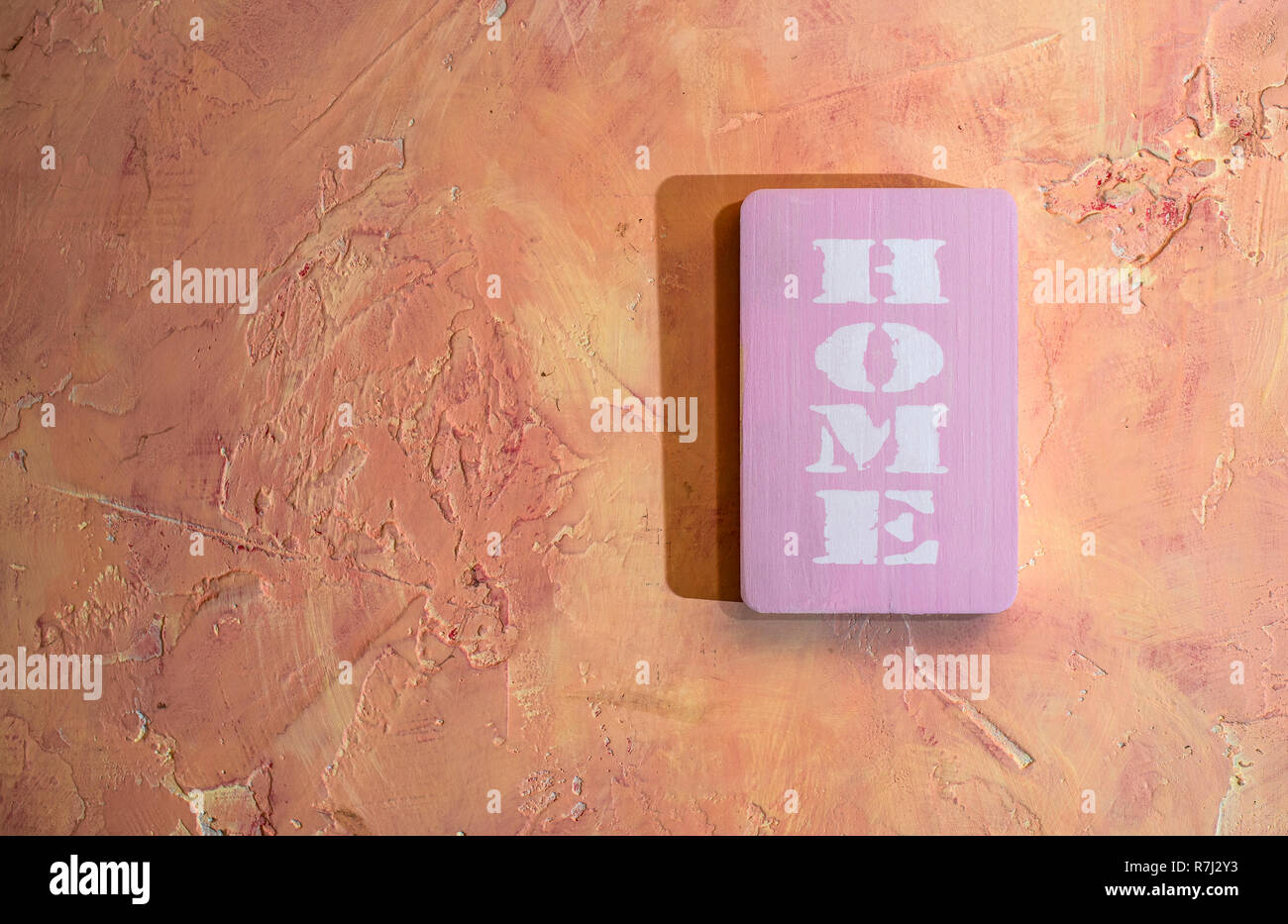 Home word on pink wall in room. Daylight from window Stock Photo - Alamy
