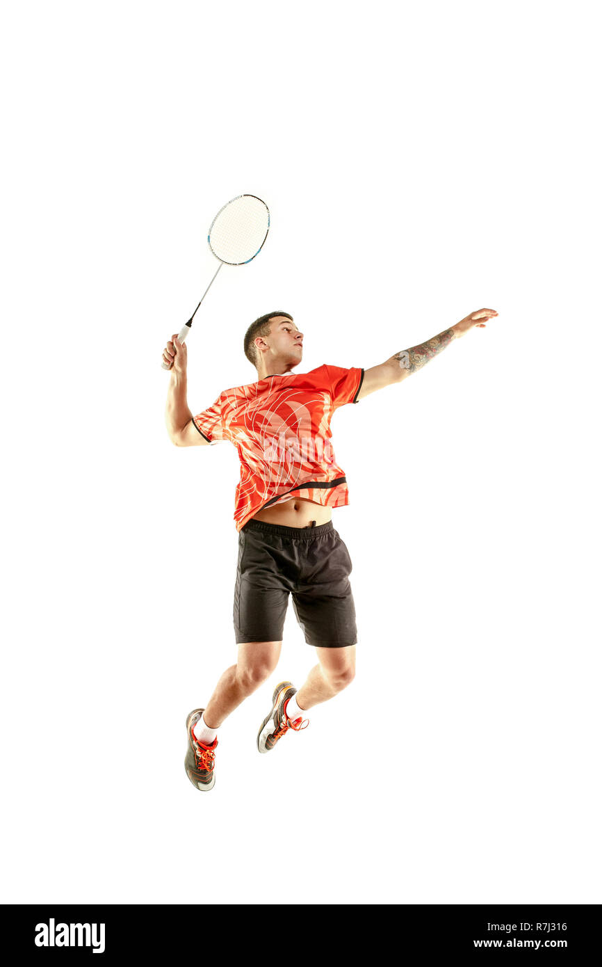 Young man playing badminton over white studio background. Fit male ...