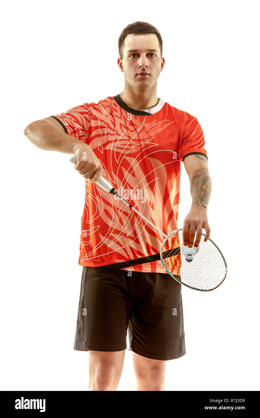 Young man playing badminton over white studio background. Fit male ...