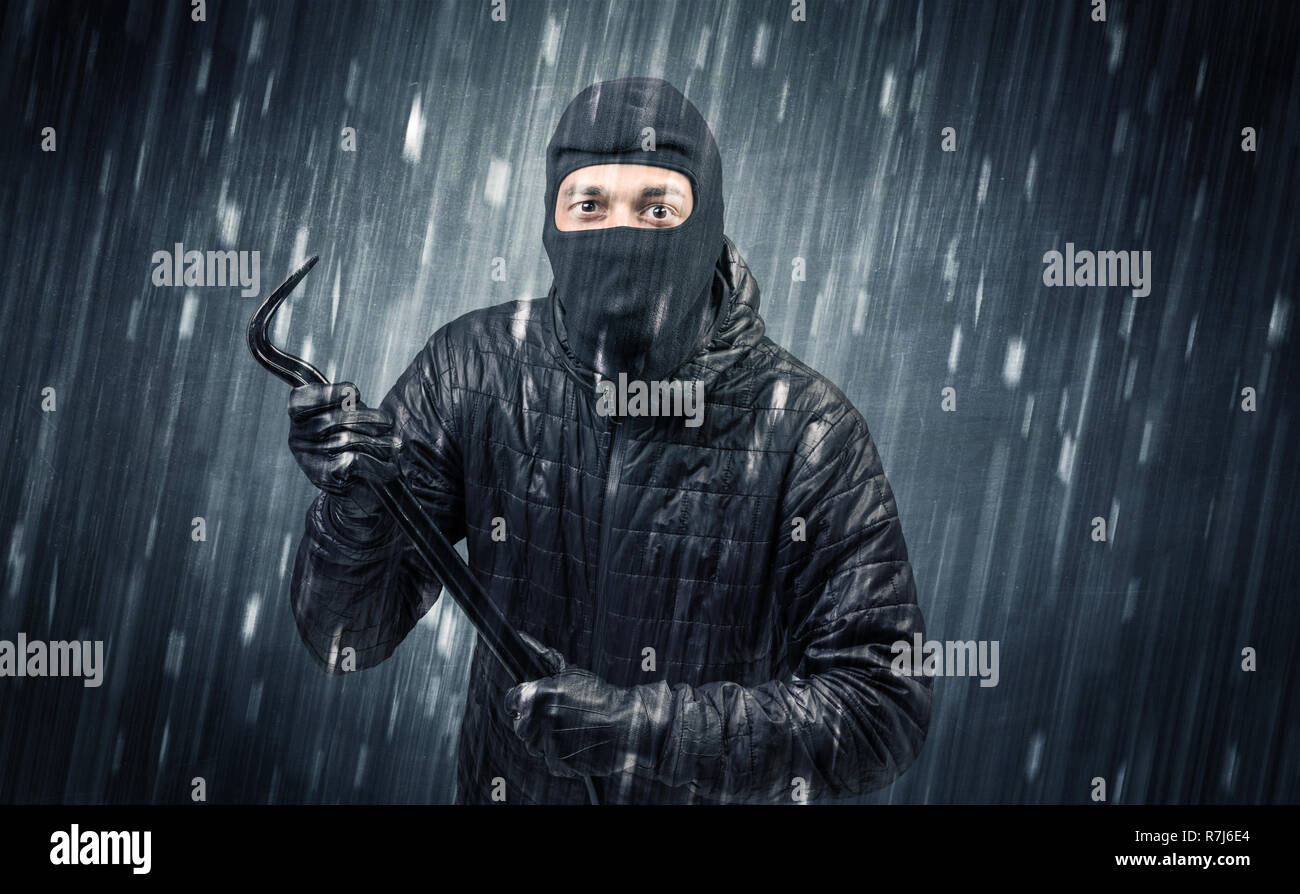 Burglar in action in black clothes with rainy concept Stock Photo - Alamy