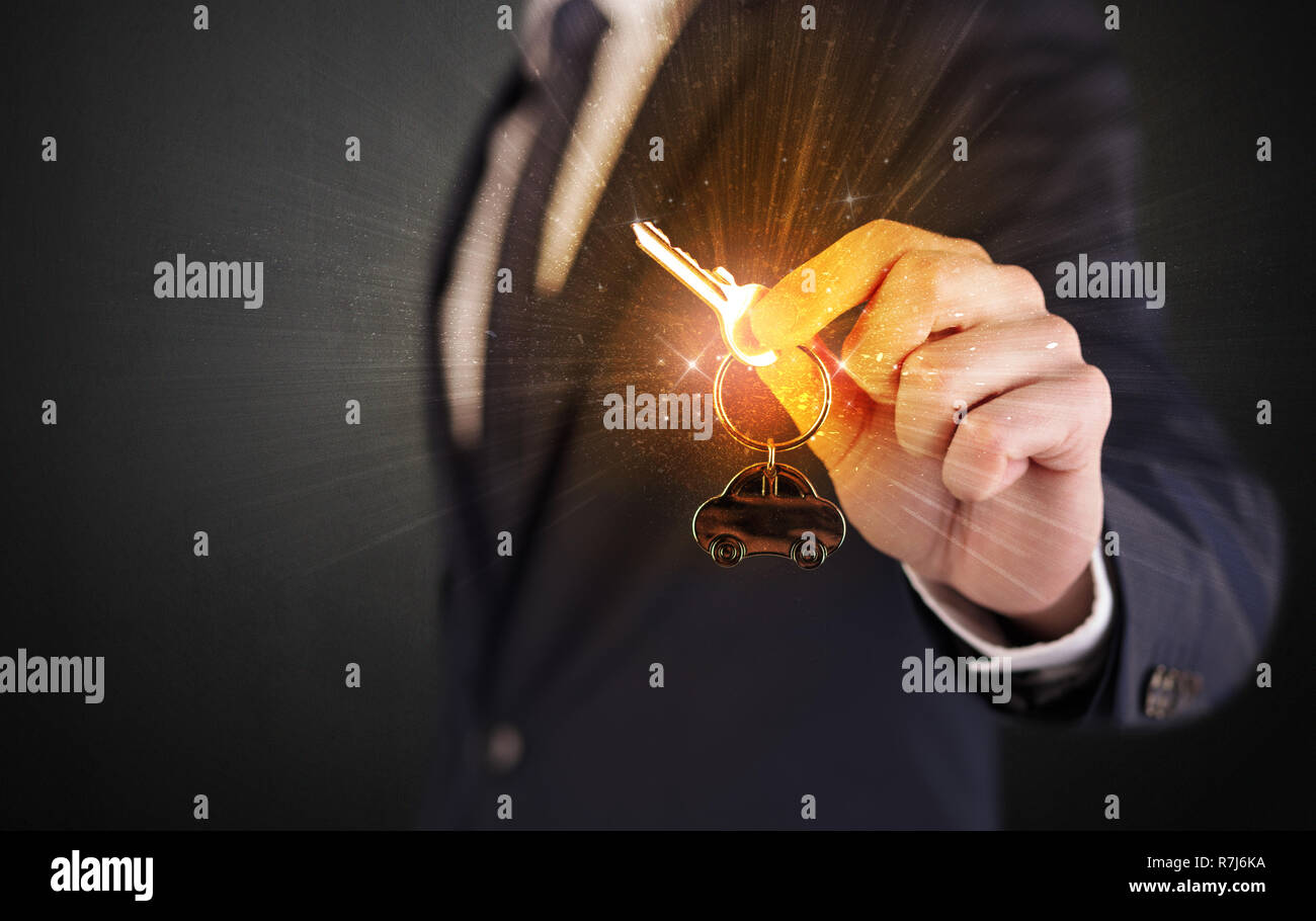Formal man hand over shiny keys with dark background Stock Photo - Alamy