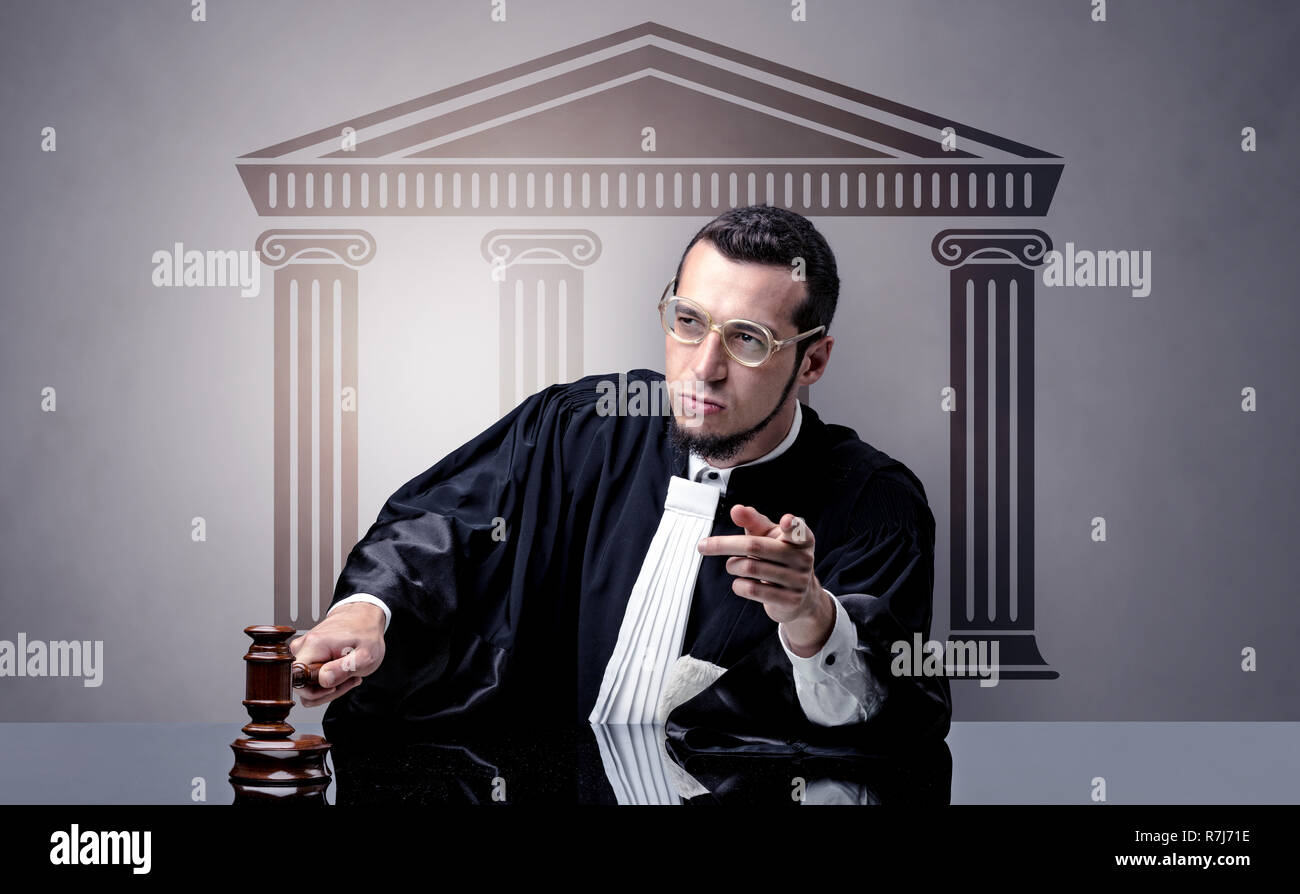 Young judge in front of a courthouse symbol making decision Stock Photo ...