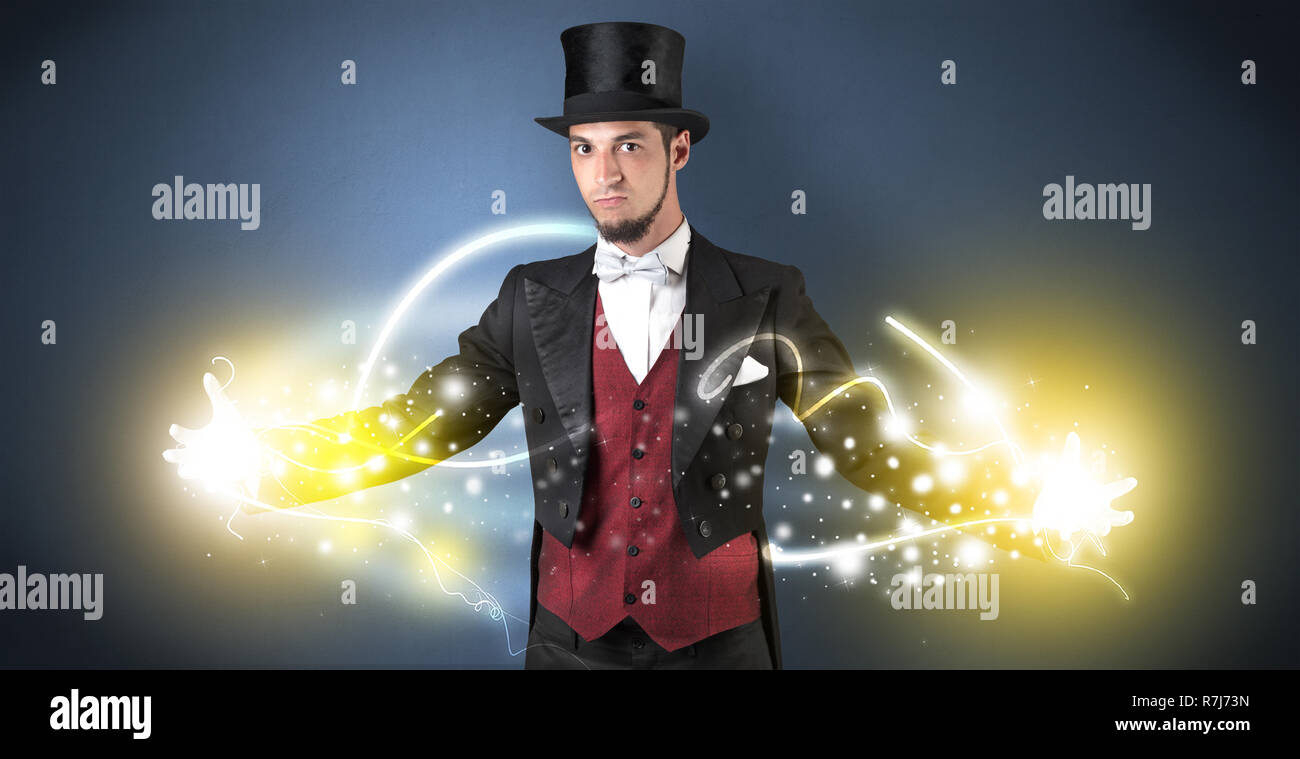 Magician holding his sparkling power between his two hand Stock Photo ...