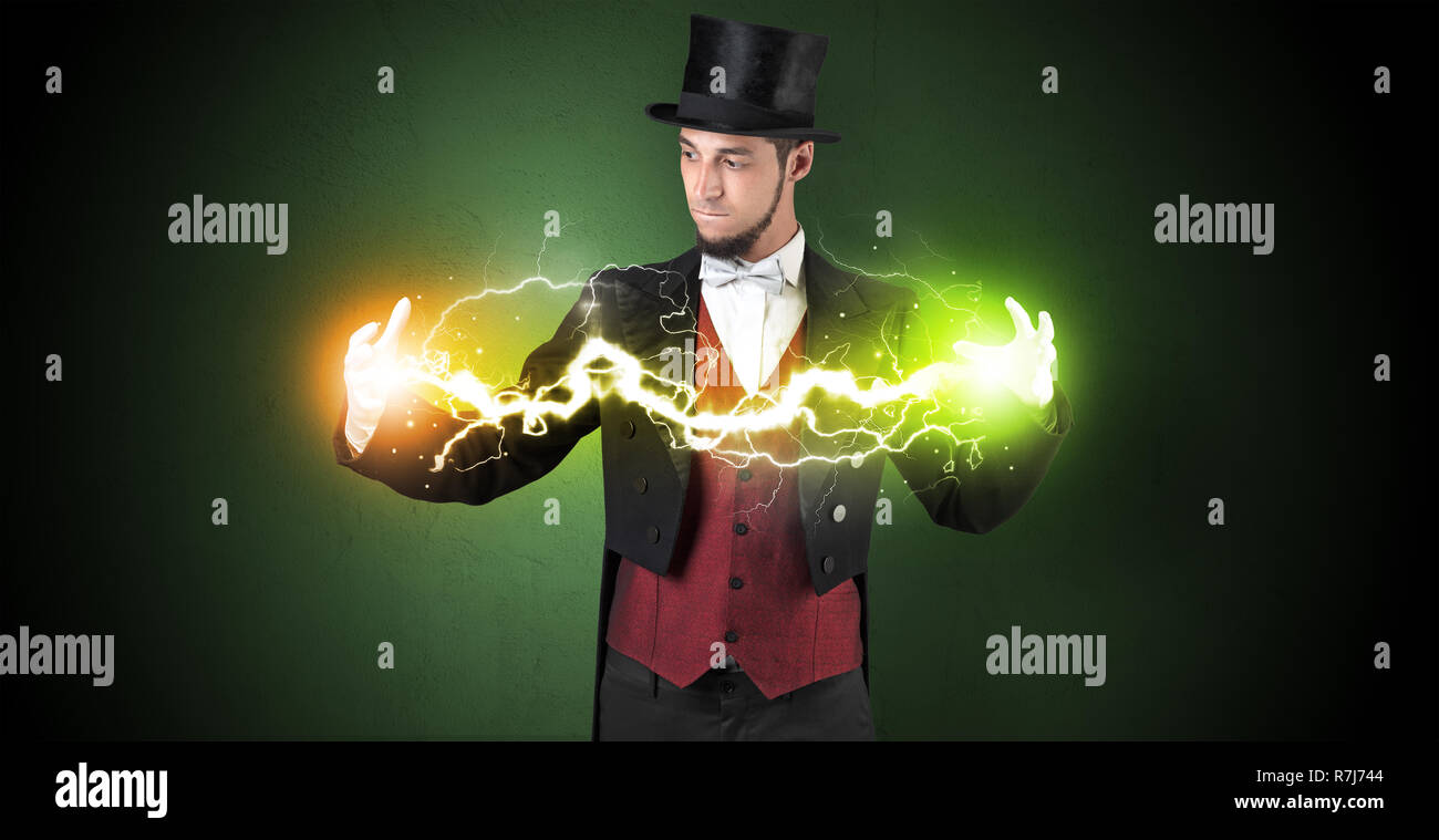 Magician sparkling super power between his two hands Stock Photo - Alamy