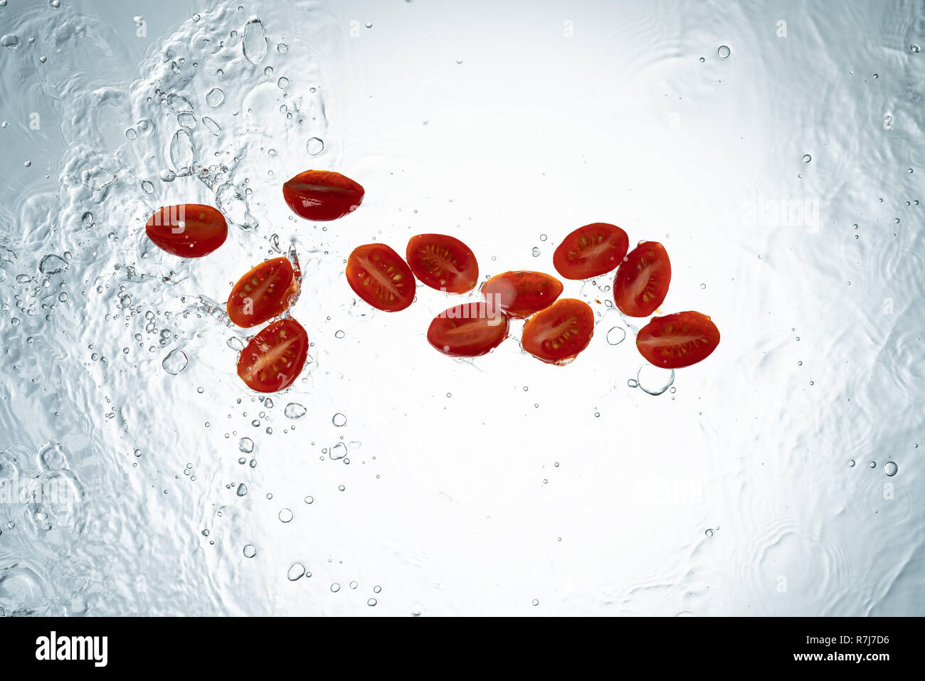 Freeze Motion Cherry tomatos water splash Stock Photo - Alamy