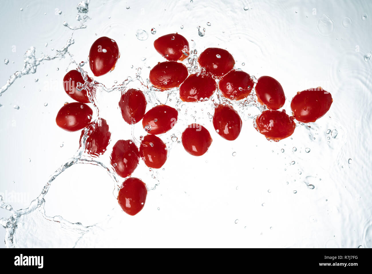 Freeze Motion Cherry tomatos water splash Stock Photo - Alamy