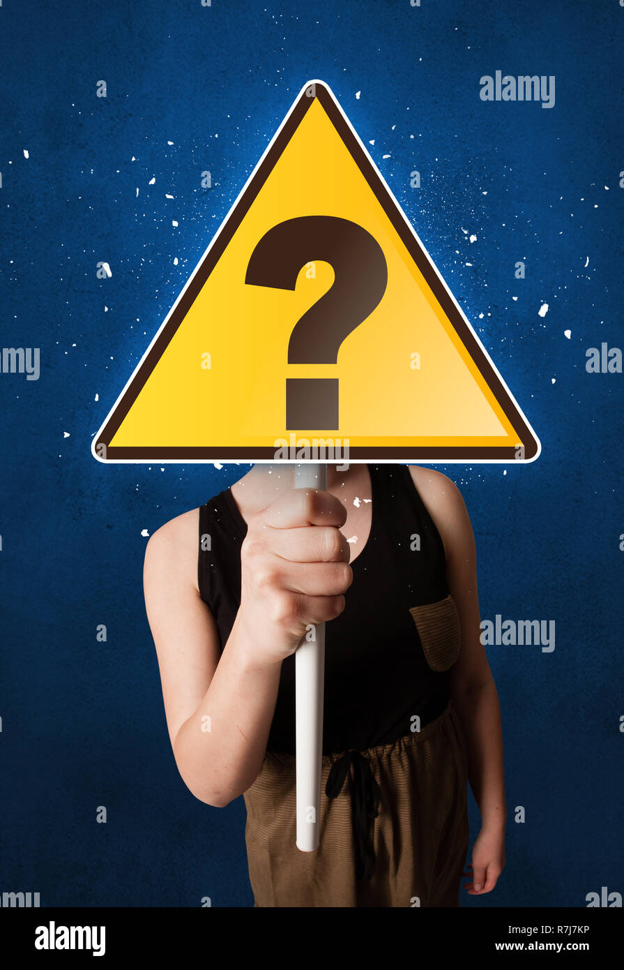 Casual young woman holding yellow sign with question mark Stock Photo ...