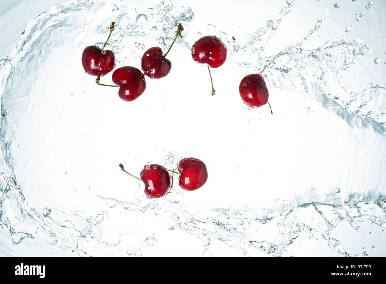 Freeze Motion cherries water splash on white background Stock Photo - Alamy