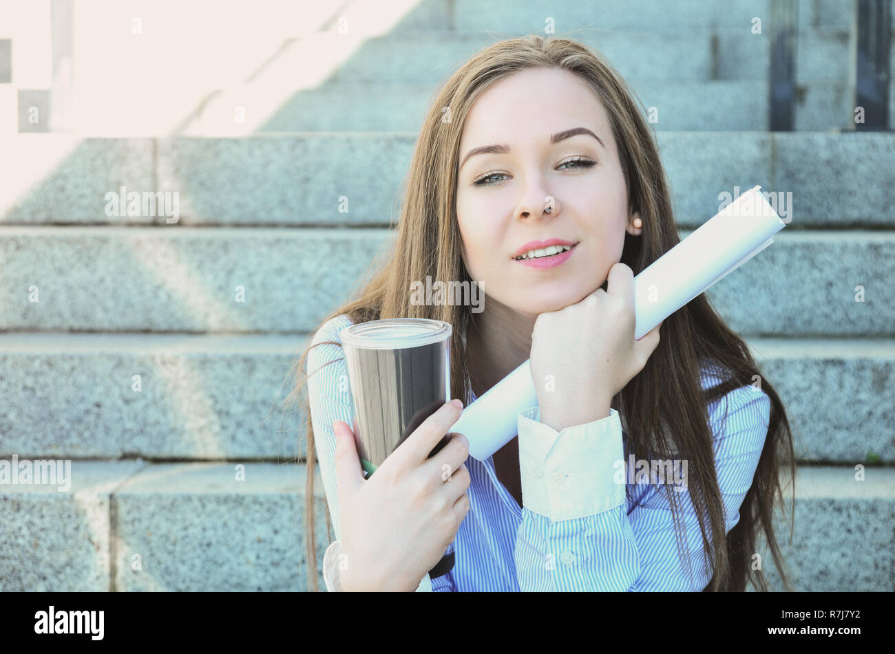 Beautiful attractive girl student, sat down on the steps during the ...