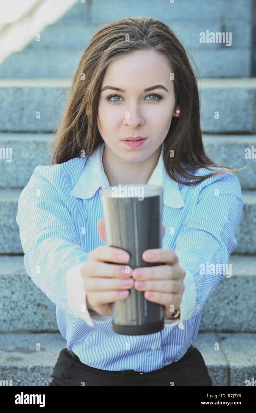 Business woman sitting on the steps during the lunch break, and offers ...