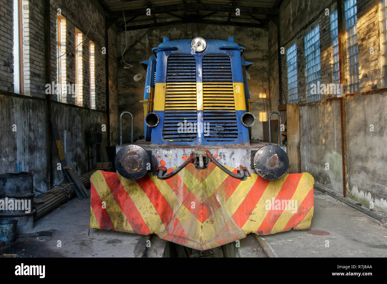 Old abandoned diesel locomotive in a former factory Stock Photo - Alamy