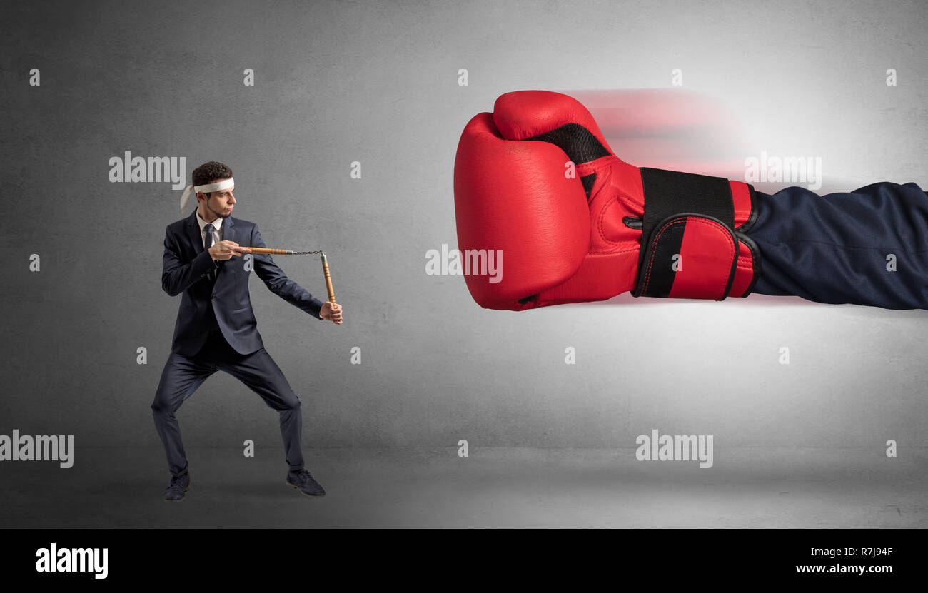 Little man fighting with a giant red boxing glove Stock Photo - Alamy