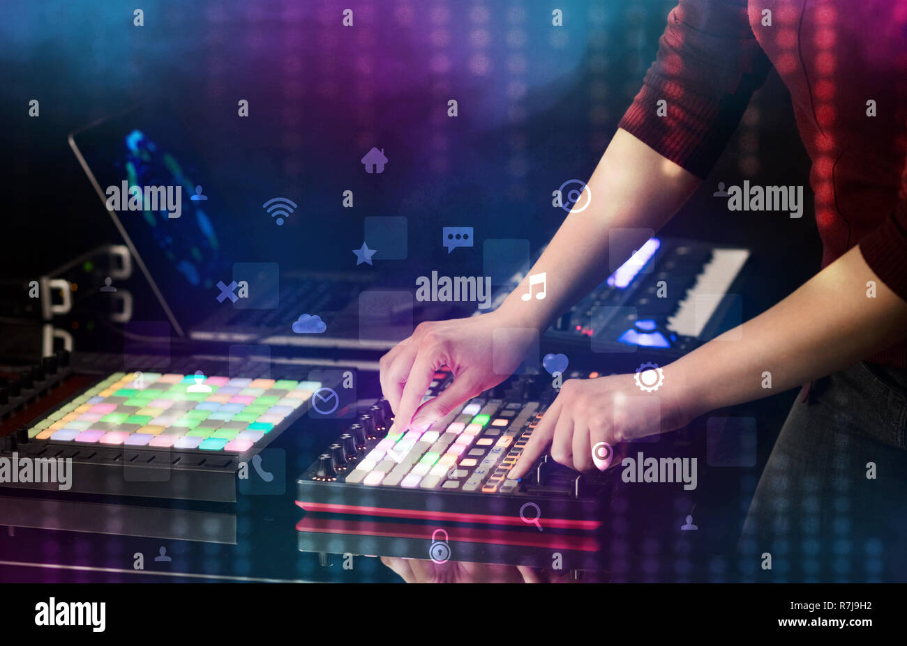 Hand mixing music on dj controller with social media concept icons ...