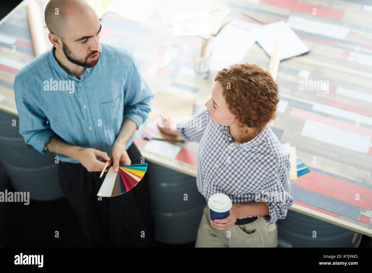 Busy designers discussing color combination during break Stock Photo ...