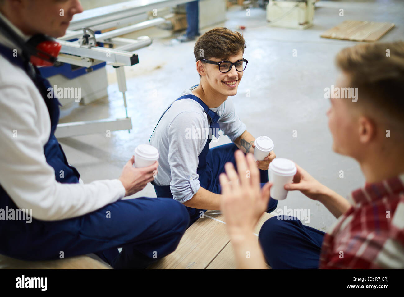 Positive young workers having break together Stock Photo - Alamy