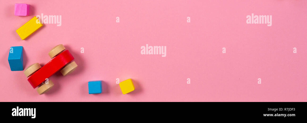 Wooden toy car with colorful cubes on pink banner background Stock ...