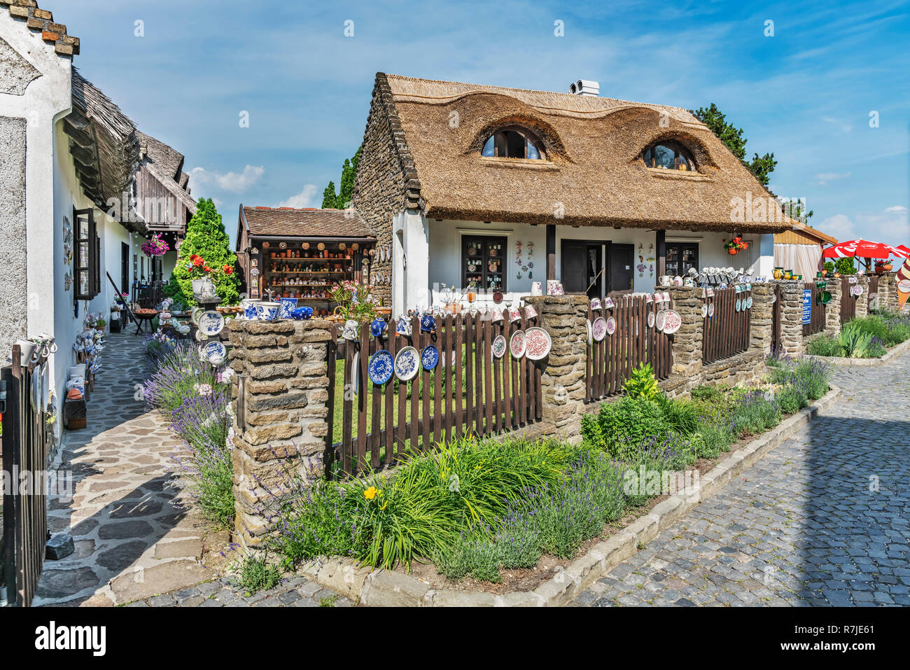Old farmhouse with thatched roof. Cups and plates are sold, Tihany ...