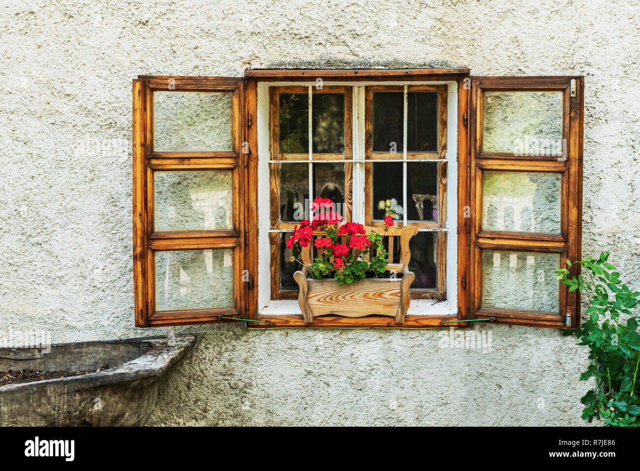 Wooden window with flower box and red geraniums on a house in Tihany ...