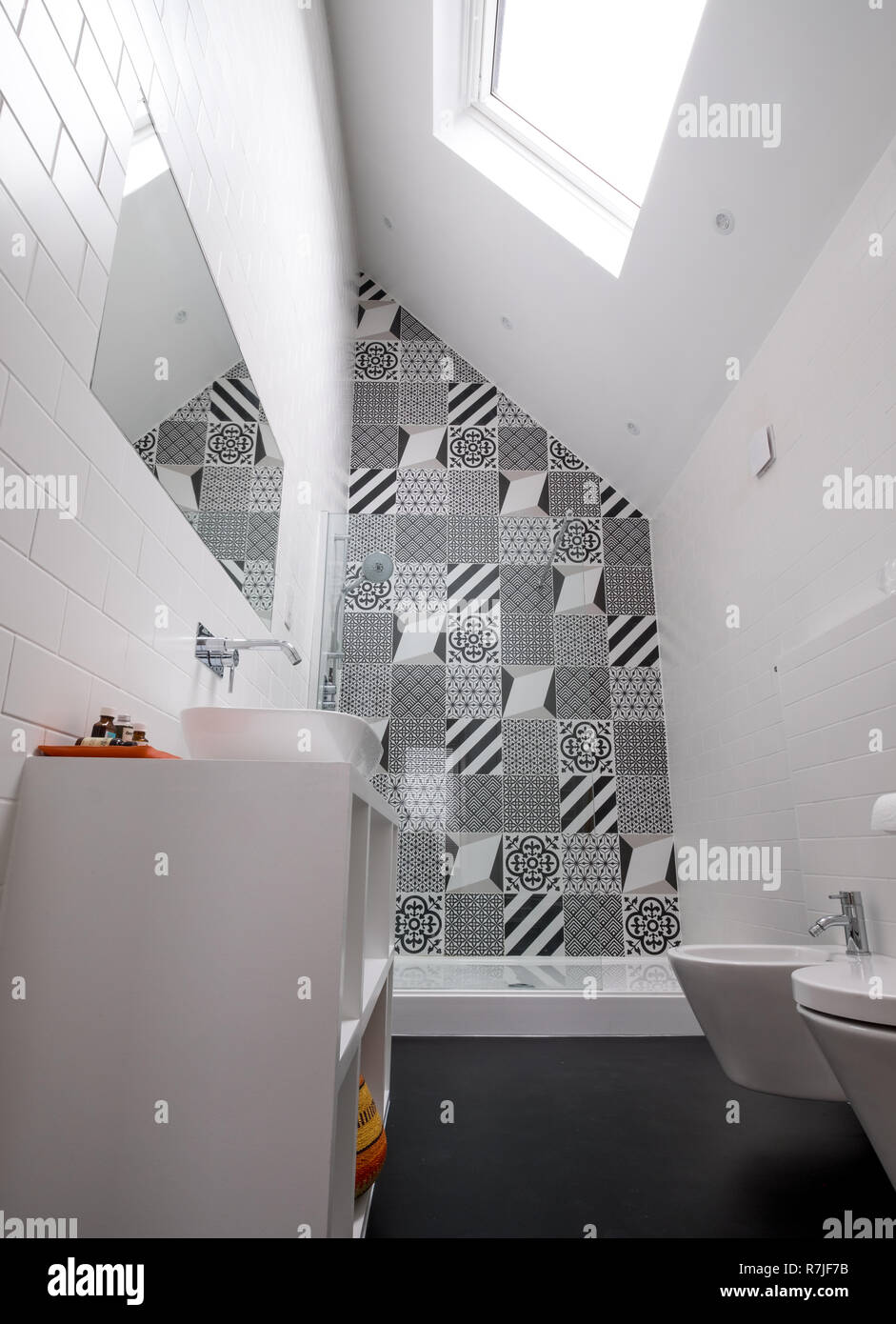 Modern loft bathroom with high ceiling, walk in shower and black and ...