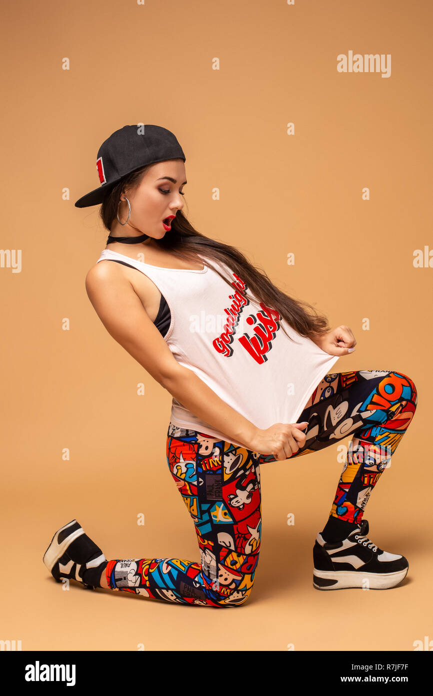 Modern style dancer posing on studio background. Hip hop, jazz funk ...