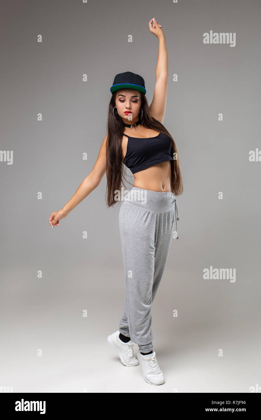 Modern dancer poses in front of the gray studio background Stock Photo ...