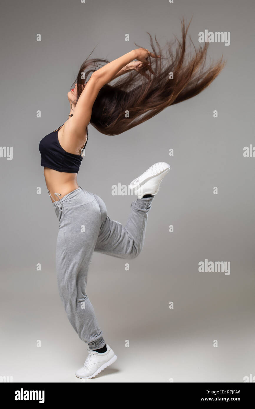 Modern dancer poses in front of the gray studio background Stock Photo ...