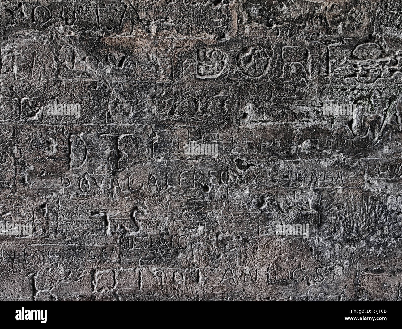 Engraved writings on stone wall Stock Photo - Alamy