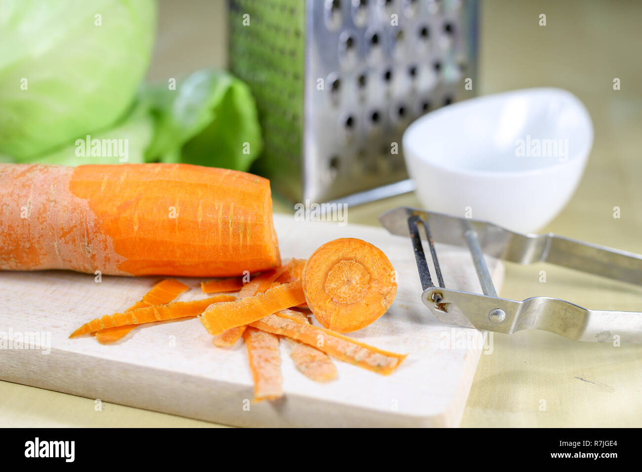 Fresh carrot grated on a metal kitchen grate. Vegetables prepared for ...