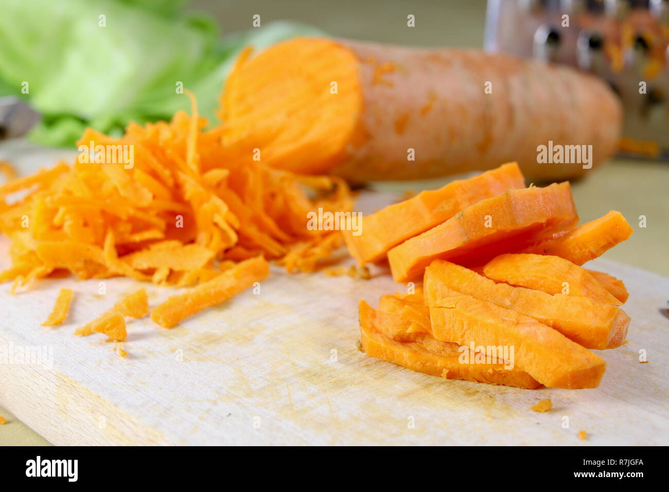 Fresh carrot grated on a metal kitchen grate. Vegetables prepared for ...