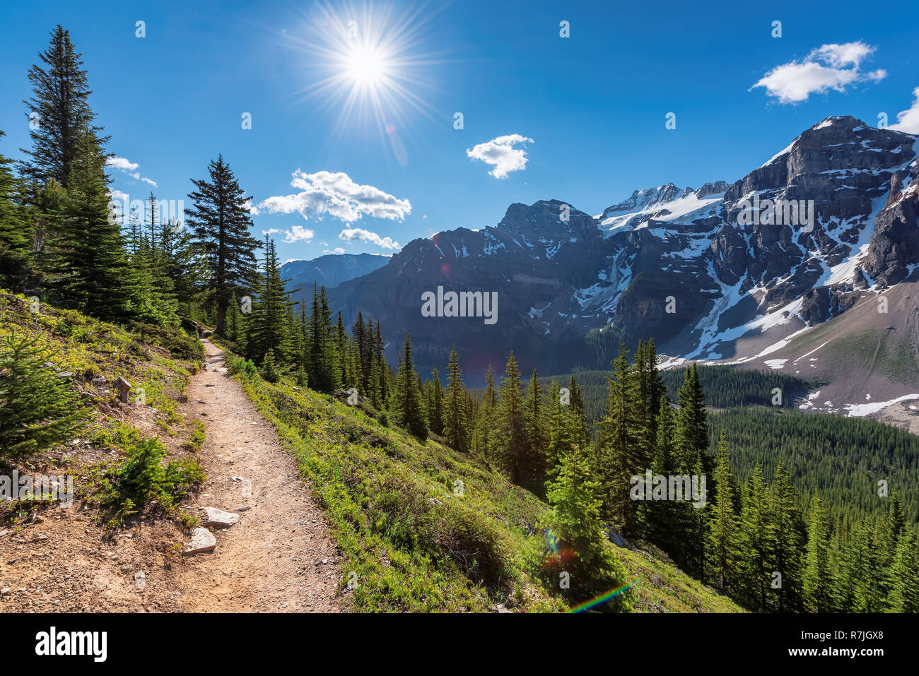 Mountain Hiking trail in the rocky mountains with snowy peaks Stock ...