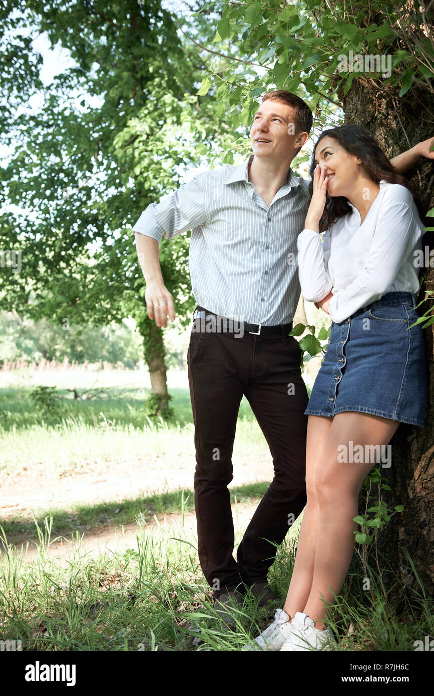 young couple walking in the forest, posing near tree, summer nature ...