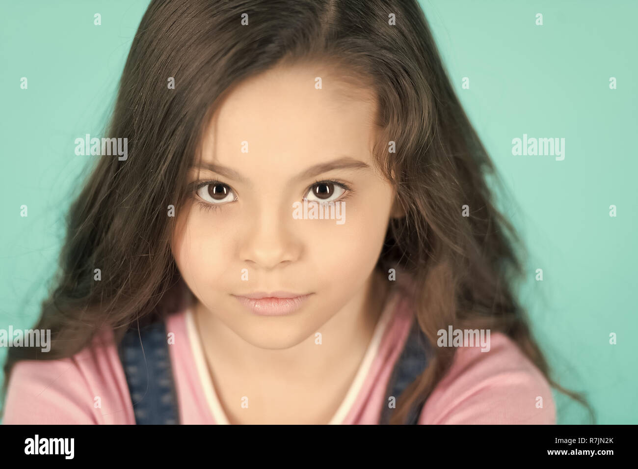 Kid model with long healthy brunette hair. Girl with adorable face on ...