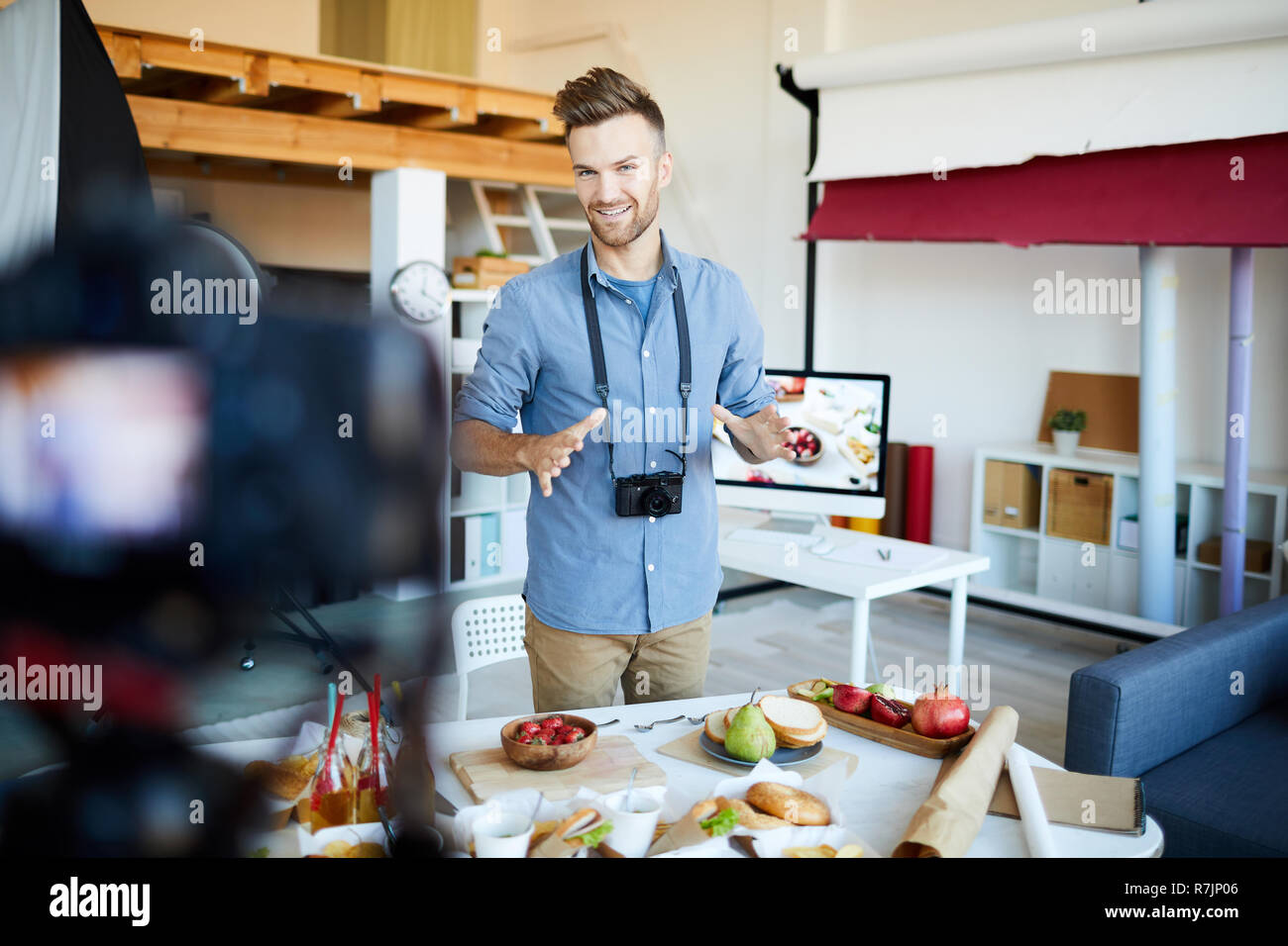 Portrait of handsome young man filming food show using photo camera ...