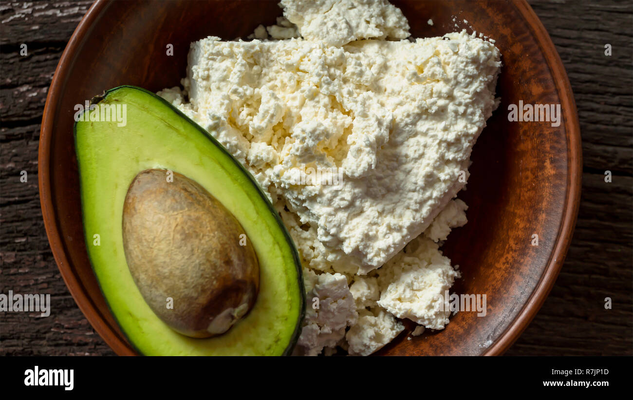Macro photo cottage cheese. Cottage cheese and Avocado on wooden table ...