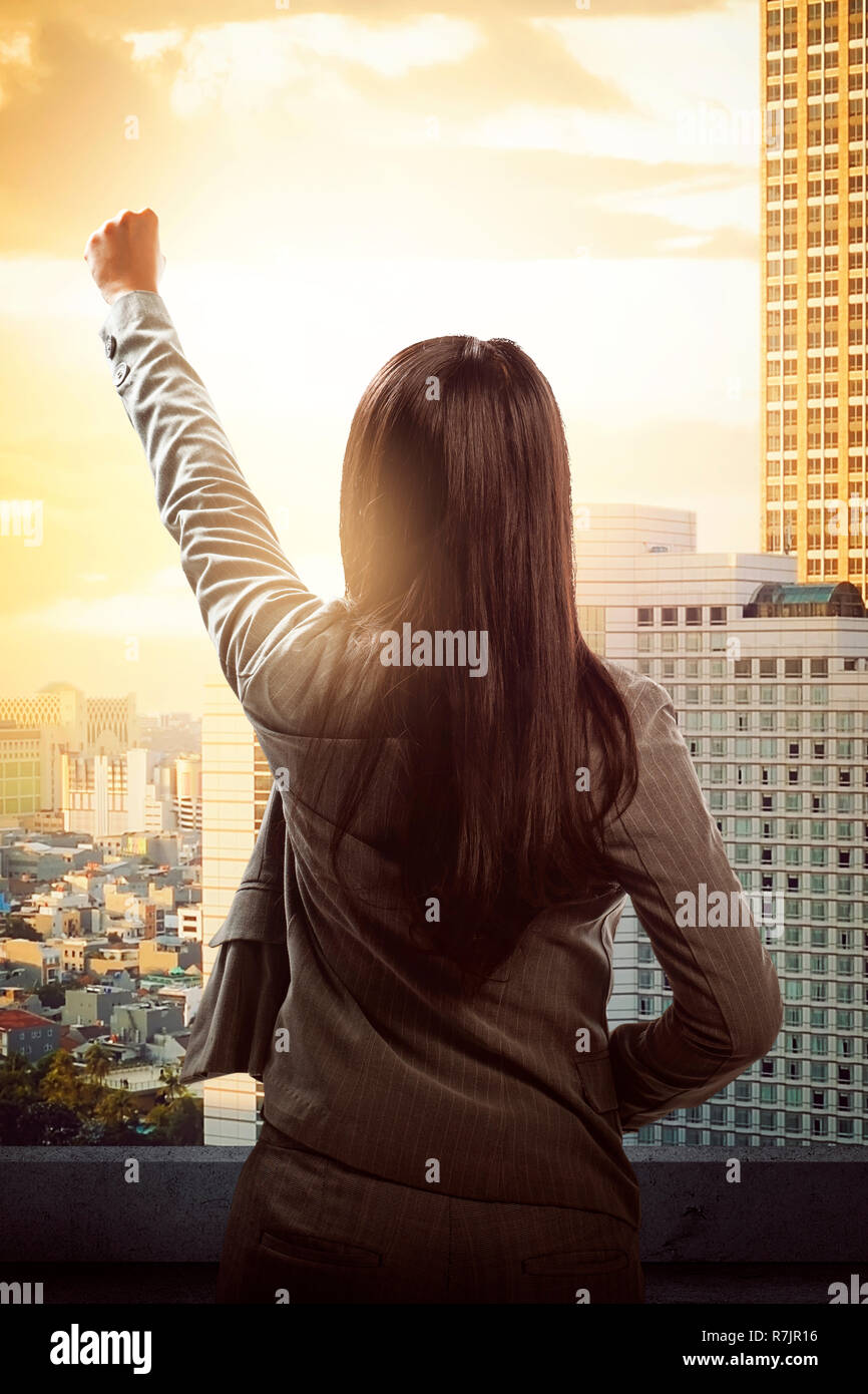 Successful asian business woman celebrating her achievement over ...