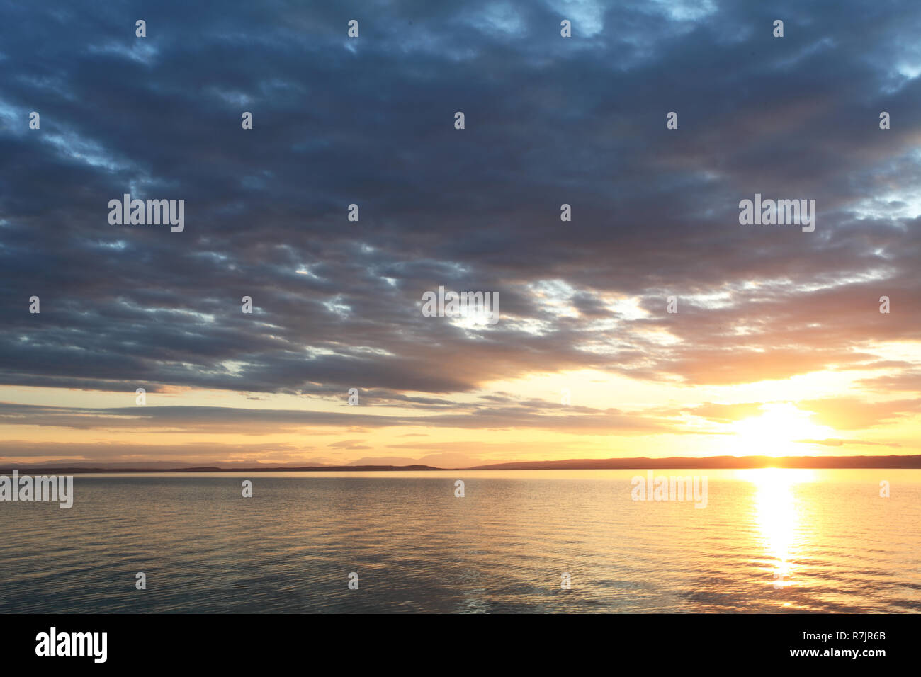 Colorful sunset over ocean Stock Photo - Alamy