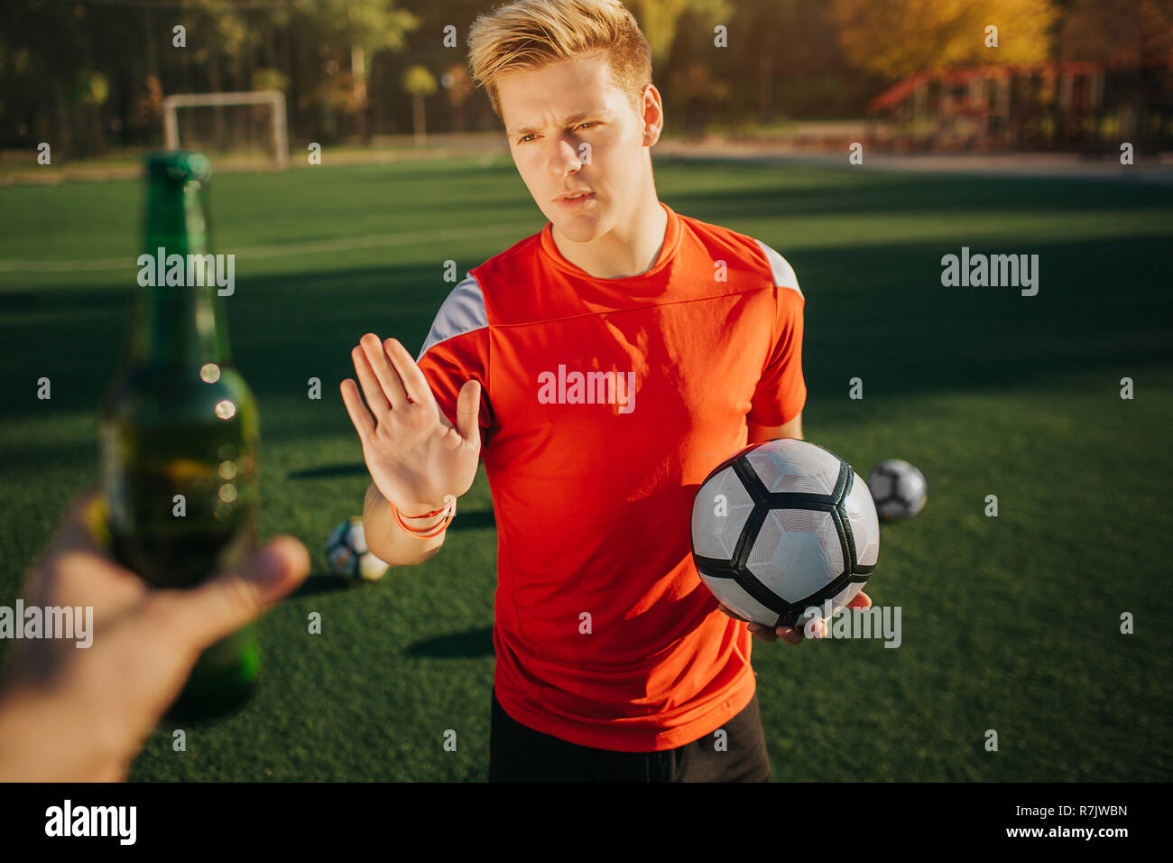 Picture of oyung player showing stop sign to human that offers him ...