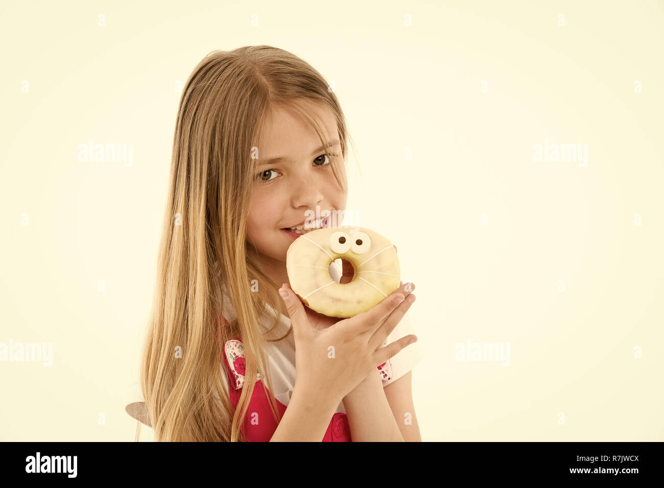 Child eat donut isolated on white. Little girl with glazed ring ...