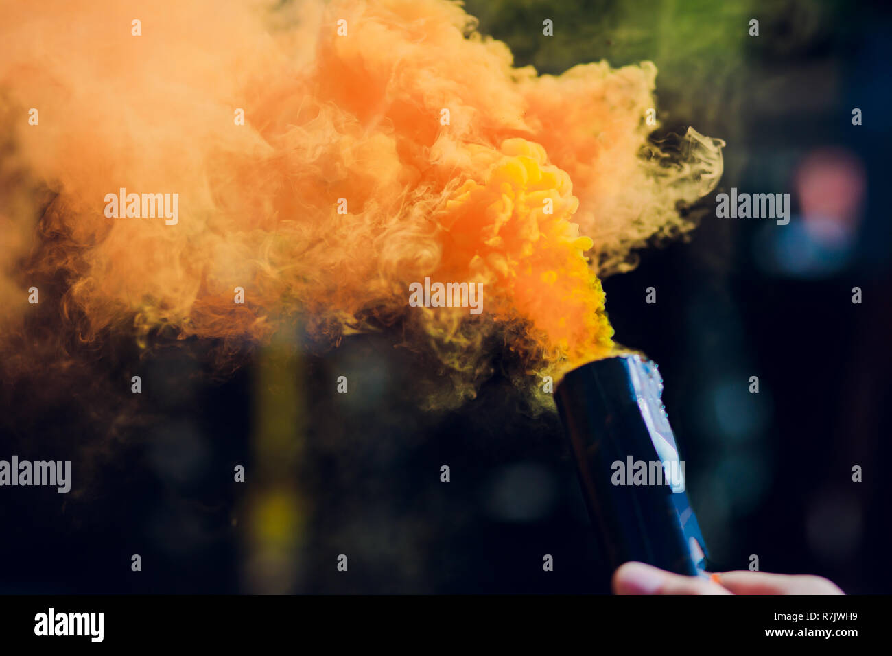 colorful orenge smoke bombs in action Stock Photo - Alamy