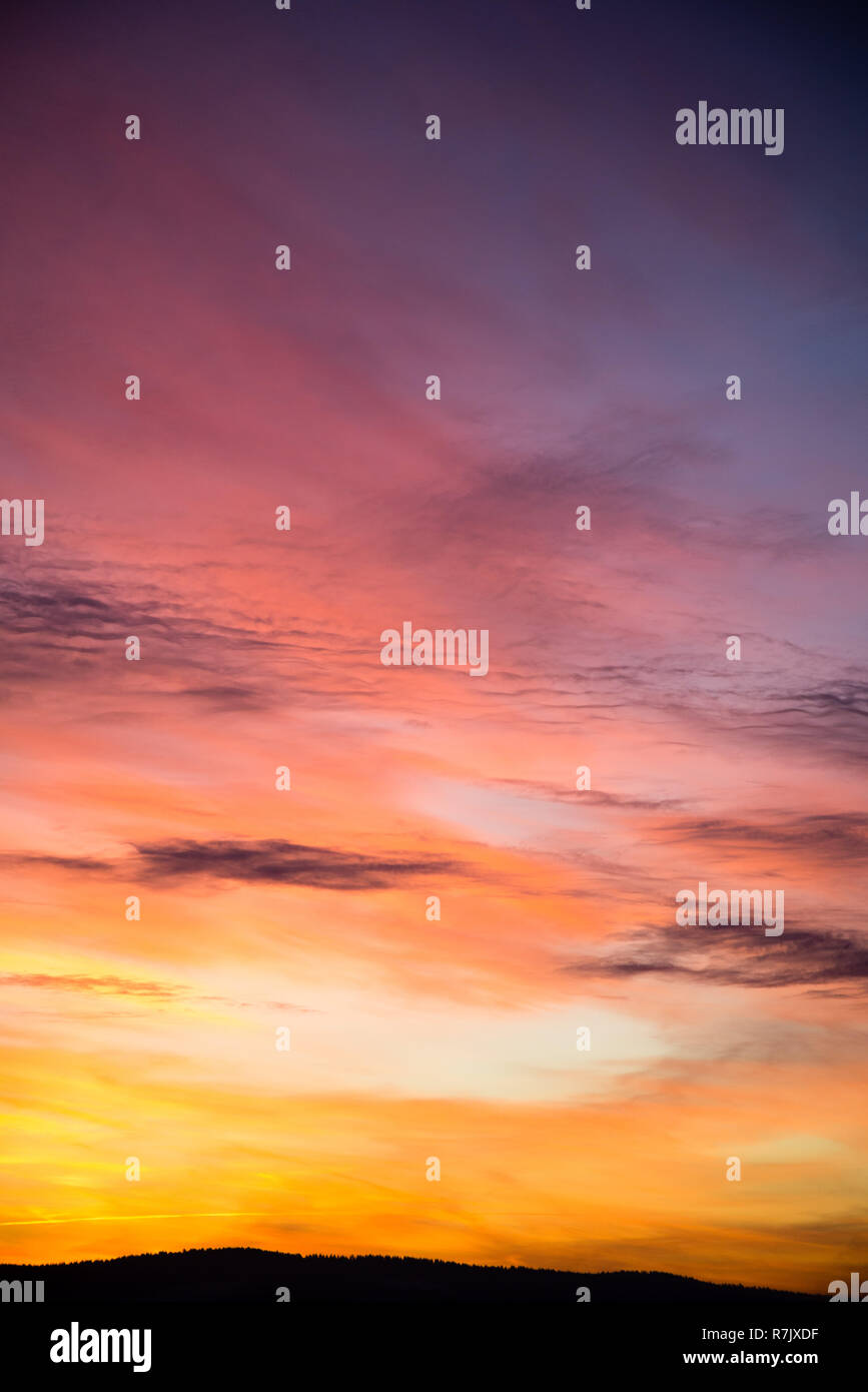 Dramatic sky with big clouds in the sunset. The sun is beautifully ...