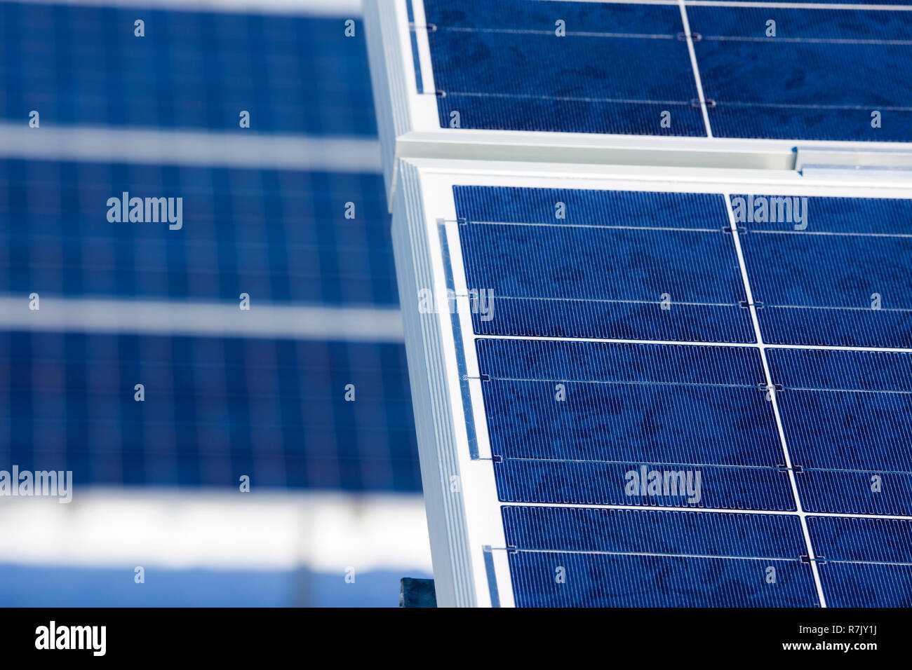 Alternative energy - rack of brand new solar panels. Blue sky ...