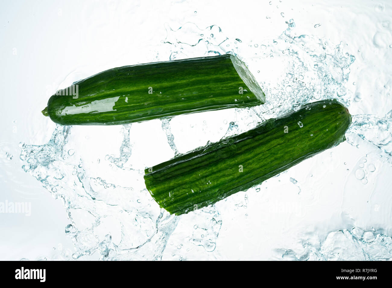 Cucumbers Water Splash on white background Stock Photo - Alamy