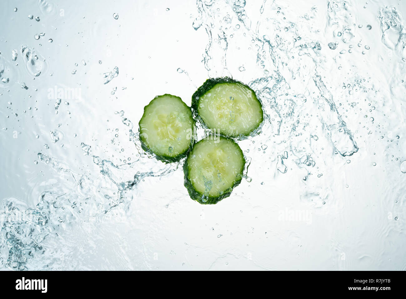 Cucumbers Water Splash on white background Stock Photo - Alamy