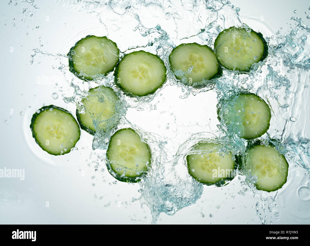 Cucumbers Water Splash on white background Stock Photo - Alamy